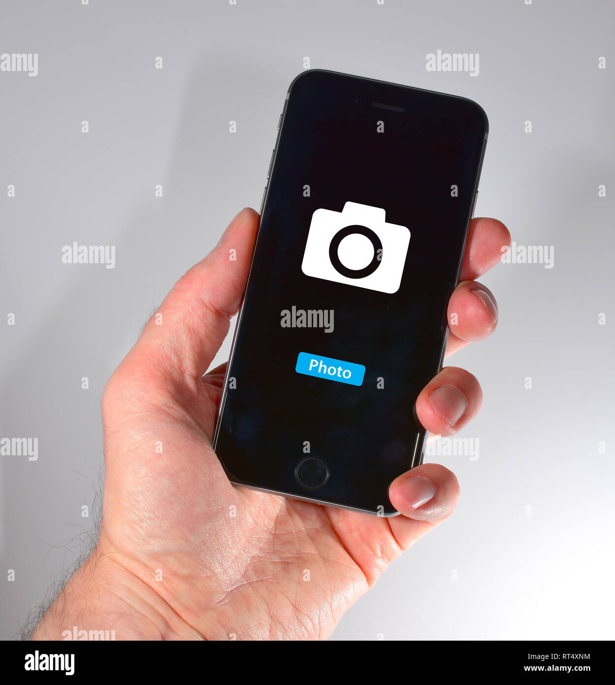 iPhone held in hand - camera symbol Stock Photo - Alamy