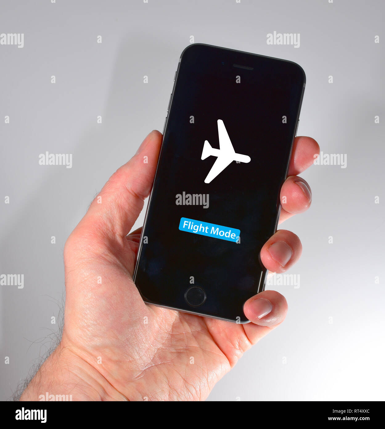 iPhone held in hand - flight mode symbol Stock Photo - Alamy