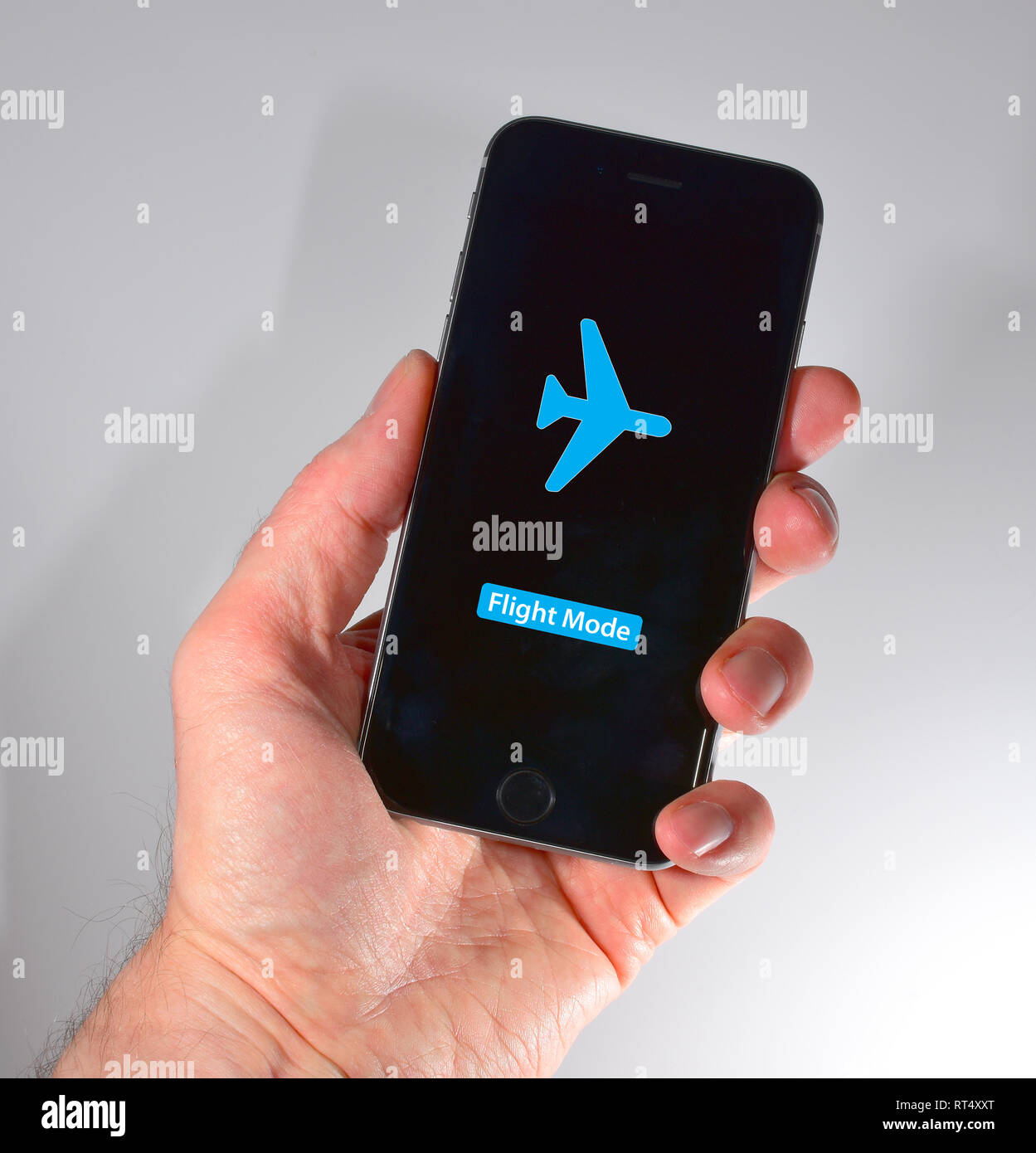 iPhone held in hand - flight mode symbol Stock Photo - Alamy
