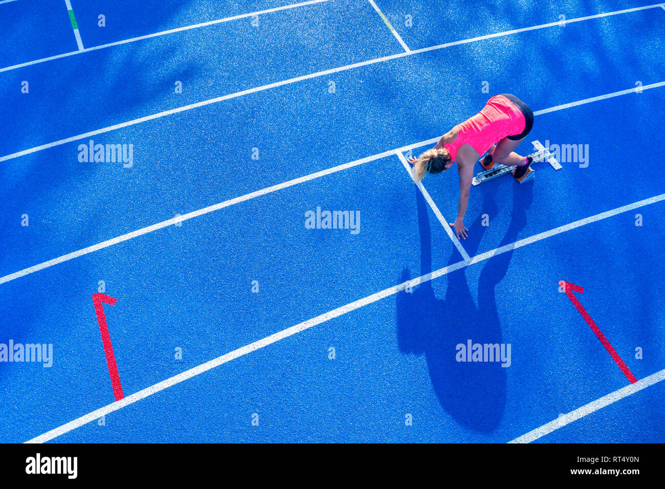Top view of female runner in starting position Stock Photo - Alamy