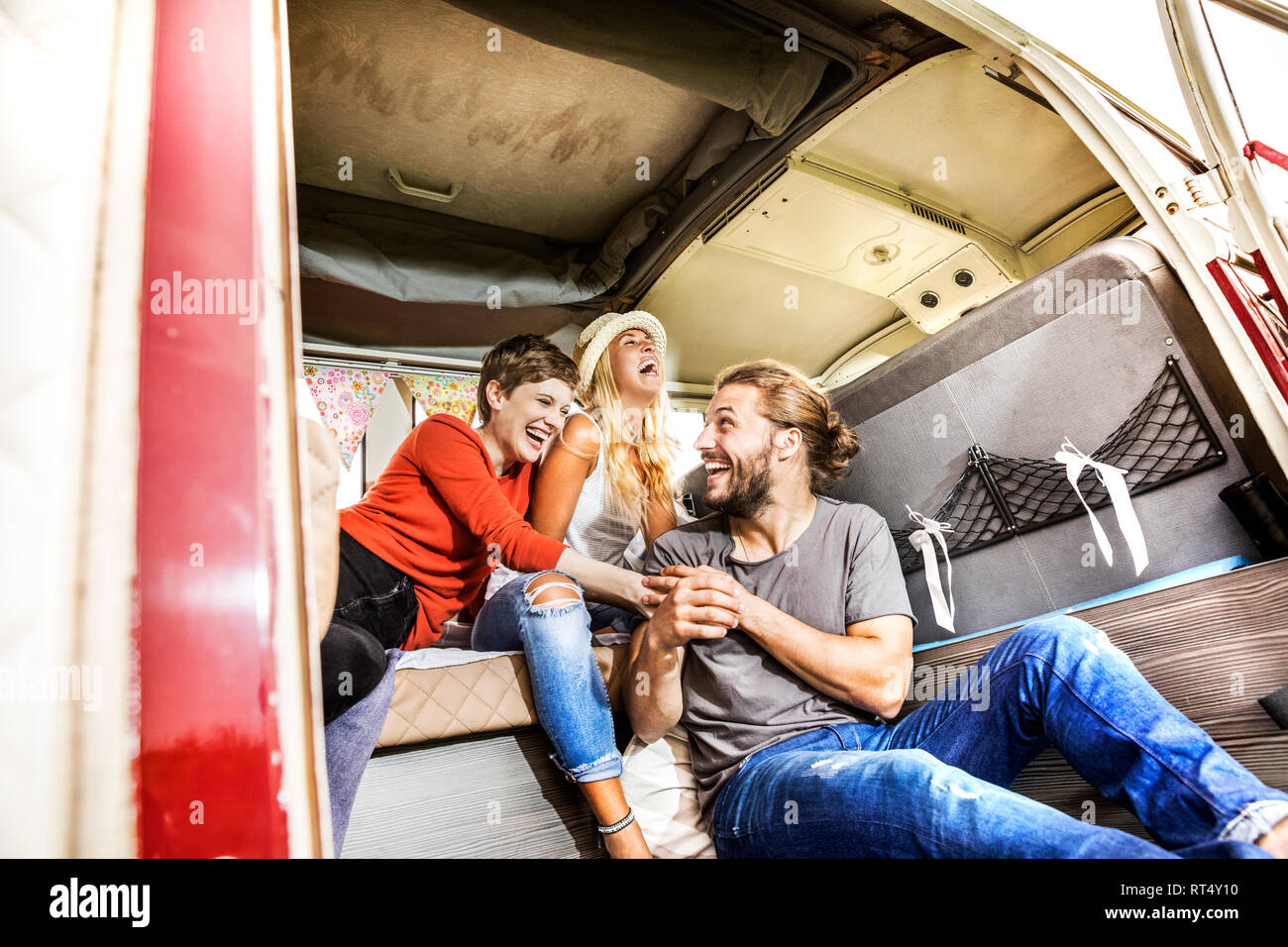 Carefree friends inside a van Stock Photo - Alamy