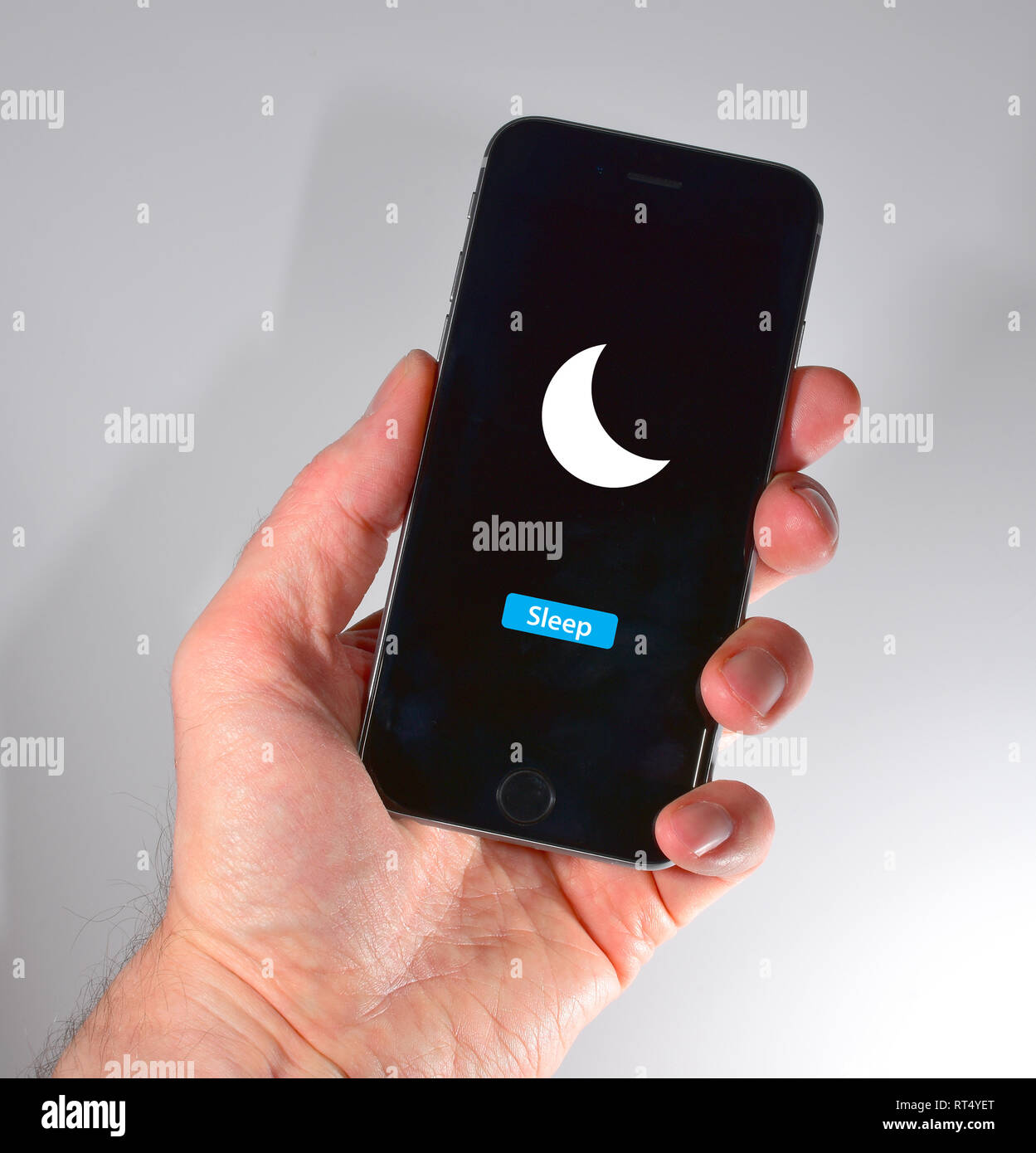 iPhone held in hand - sleep mode symbol Stock Photo - Alamy