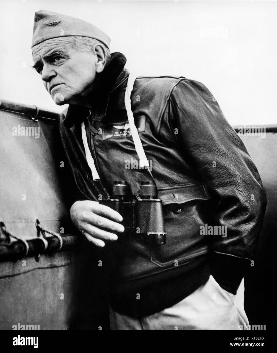 Vice Admiral William F. Halsey peering from the bridge of his ship ...