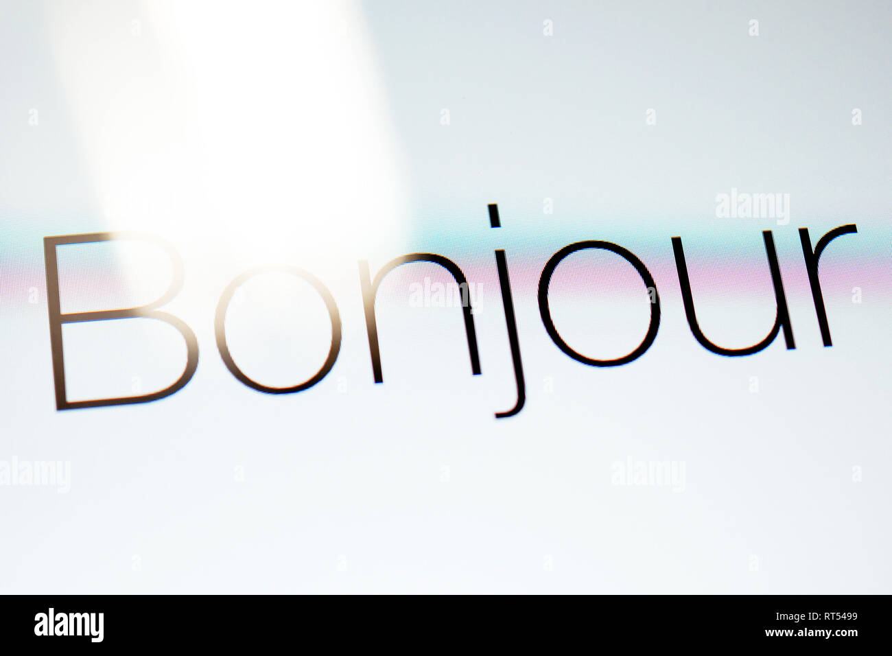 Bonjour translated Hello message on the screen of modern tablet ...