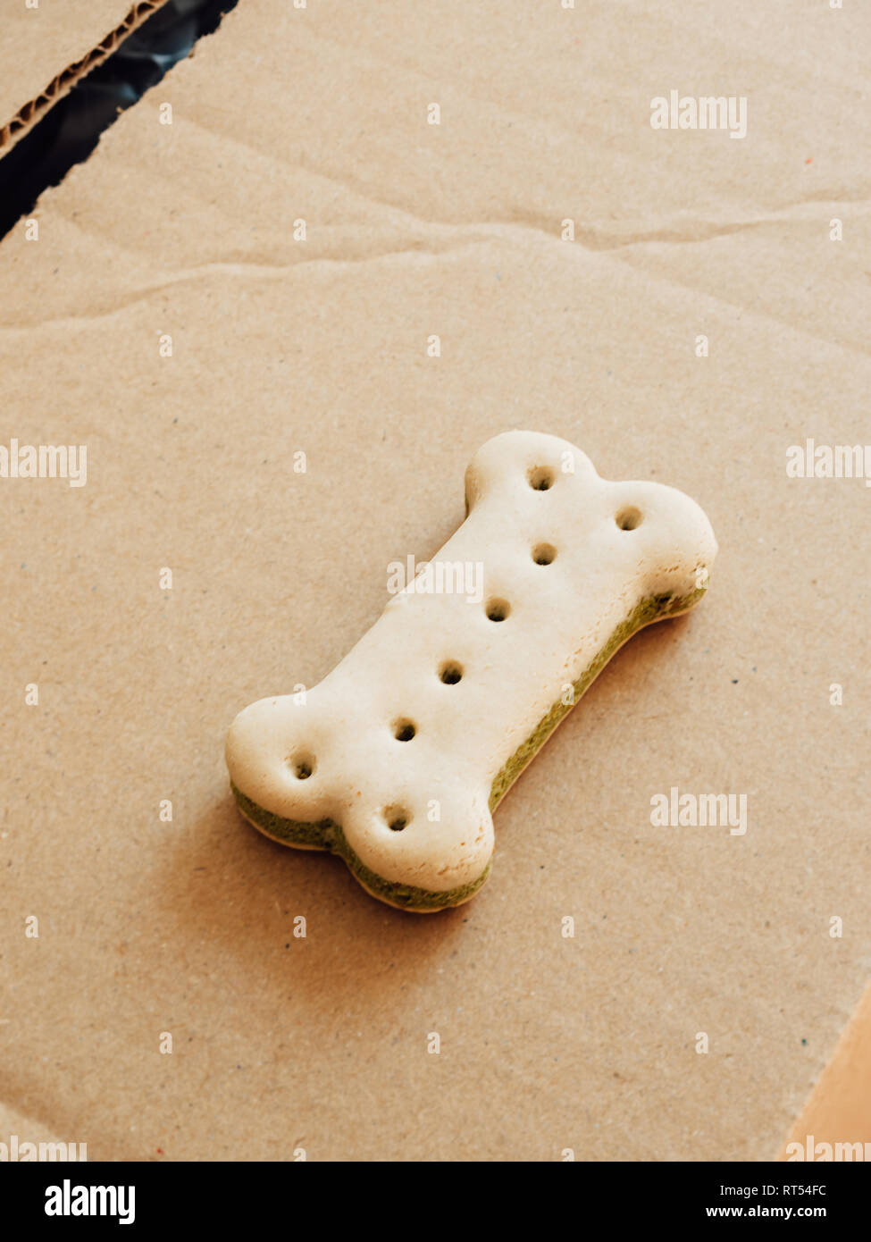 Bone shaped dry pet doog food on a cardboard box Stock Photo - Alamy