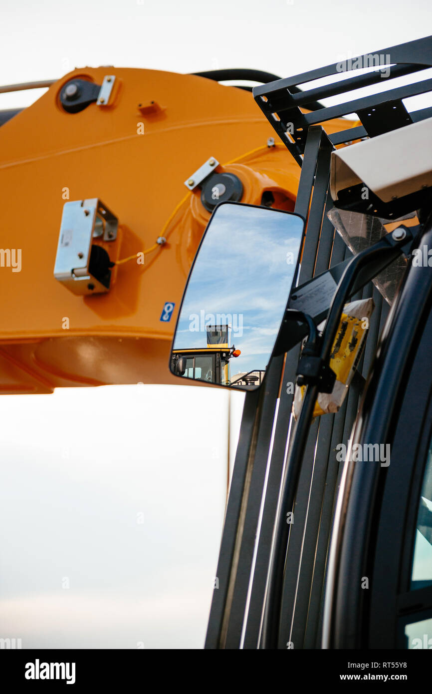 Detail of the rear-view mirror on the excavator cabin protected by ...