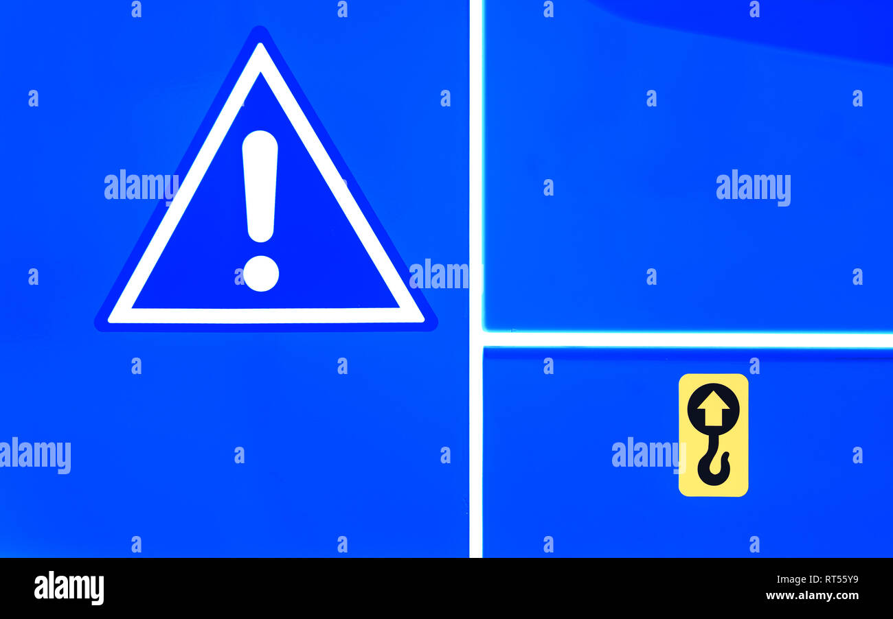 Attention blue triangle sign on the blue industrial construction ...