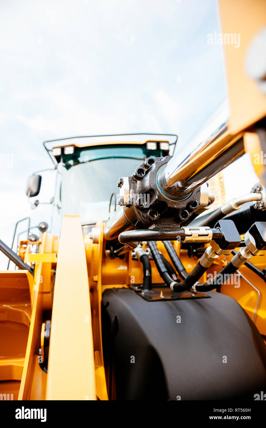 Powerful excavator front view with the details of the hydraulic bucket ...
