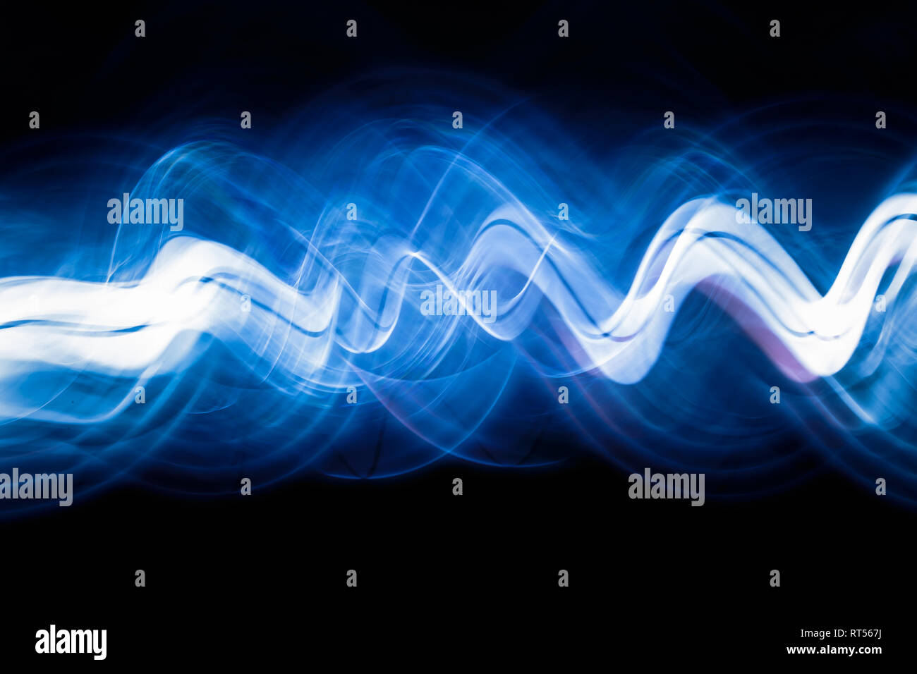 Sound waves in the visible blue color in the dark Stock Photo - Alamy