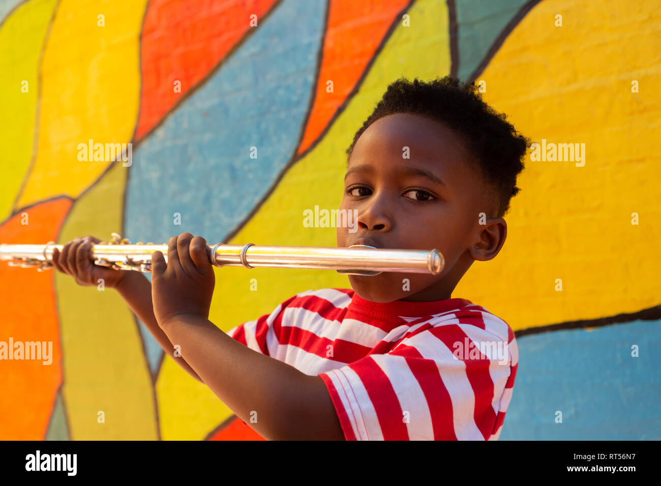 Schoolboy playing flute instrument in the school playground Stock Photo ...