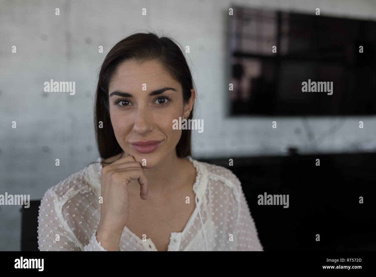 Beautiful female executive looking at camera in office Stock Photo - Alamy