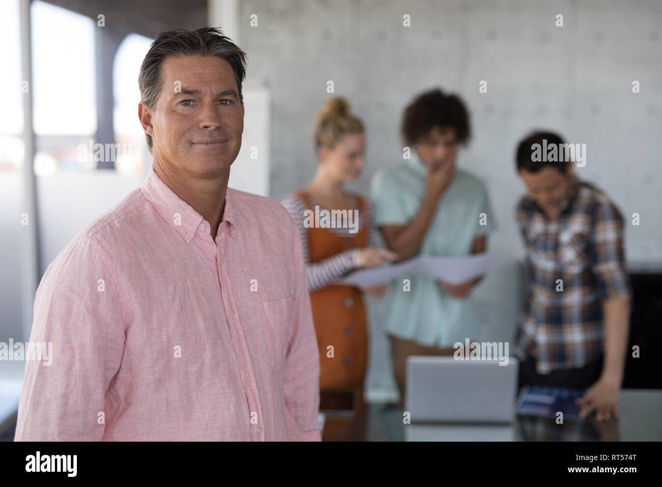 Male executive standing in office Stock Photo - Alamy