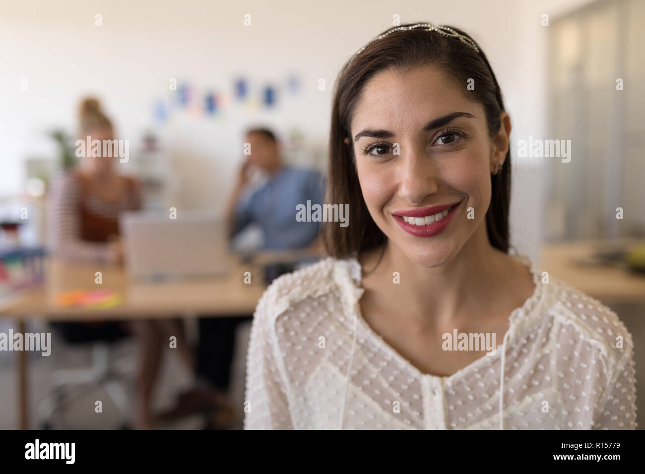 Happy female executive smiling in office Stock Photo - Alamy