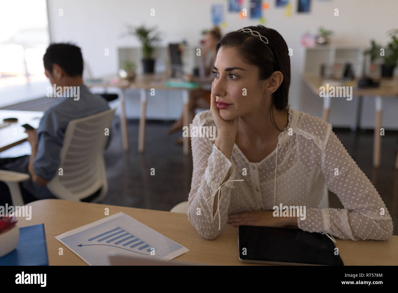 Female executive sitting at desk in office Stock Photo - Alamy