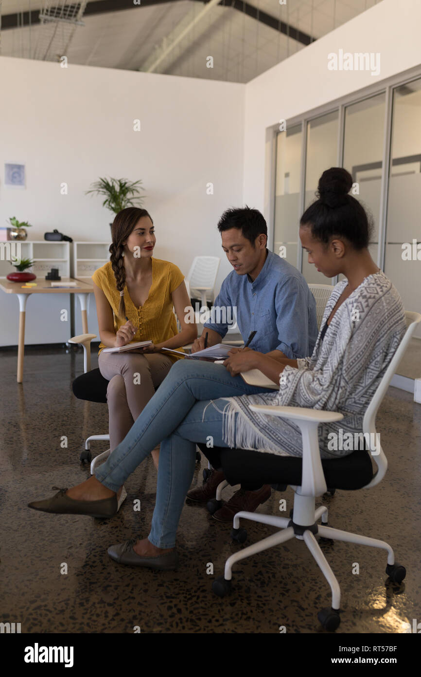 Business colleagues writing on a diary in office Stock Photo - Alamy