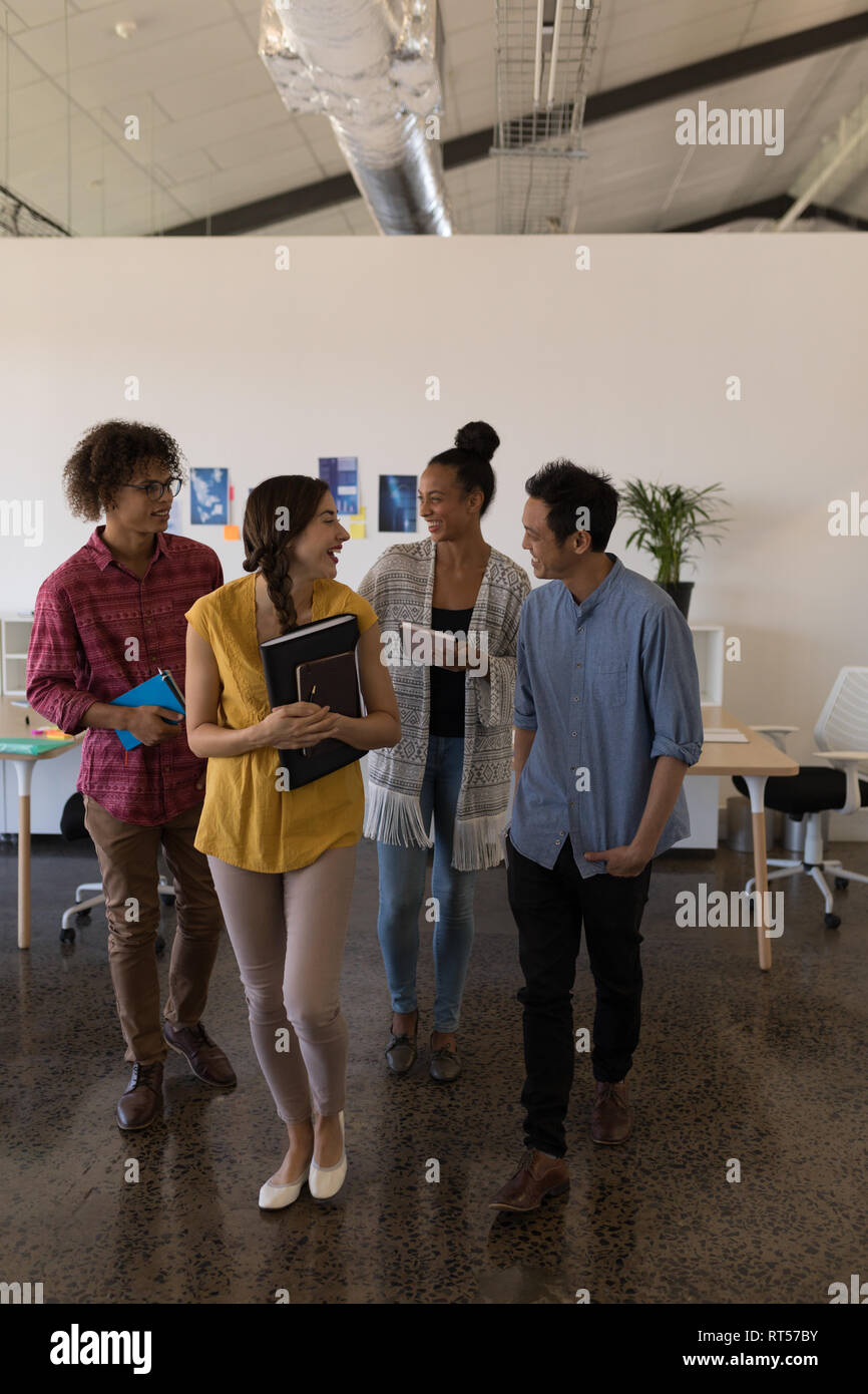 Happy colleagues interacting other in hi-res stock photography and ...