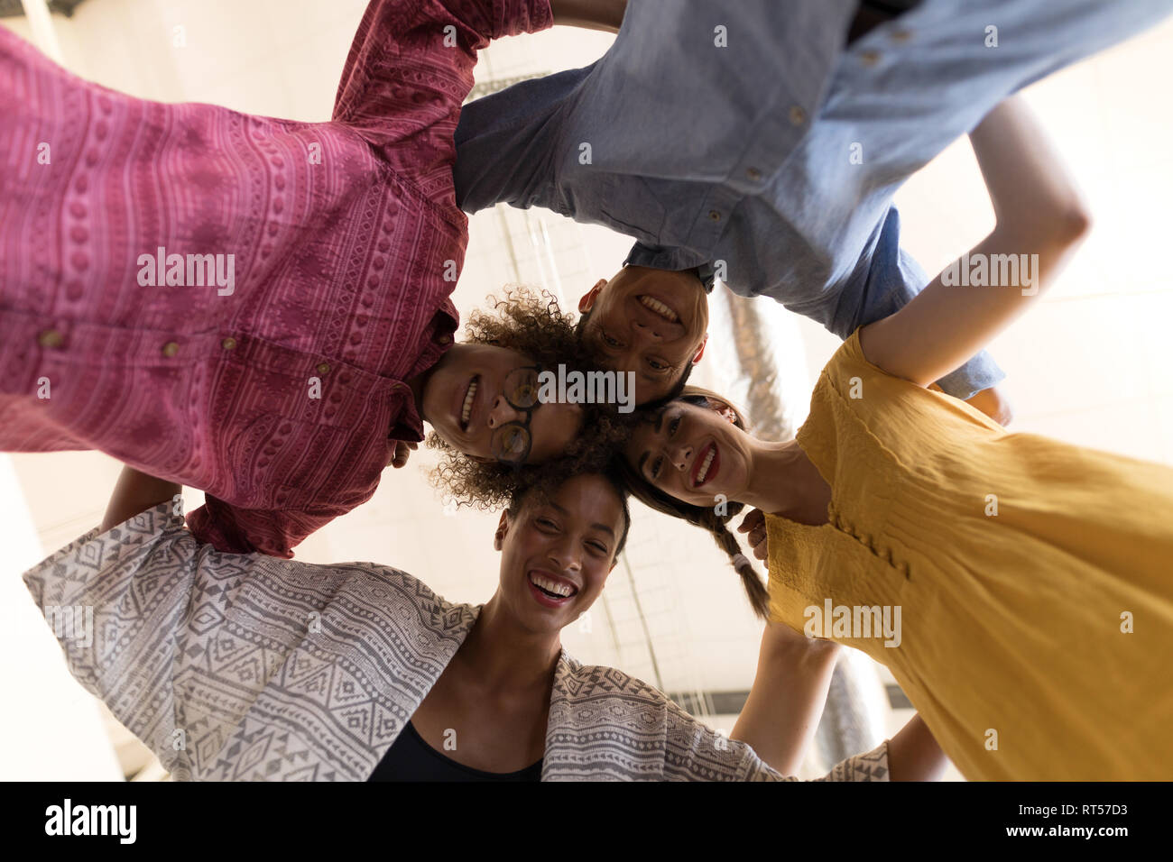 Business colleagues forming huddle in office Stock Photo - Alamy