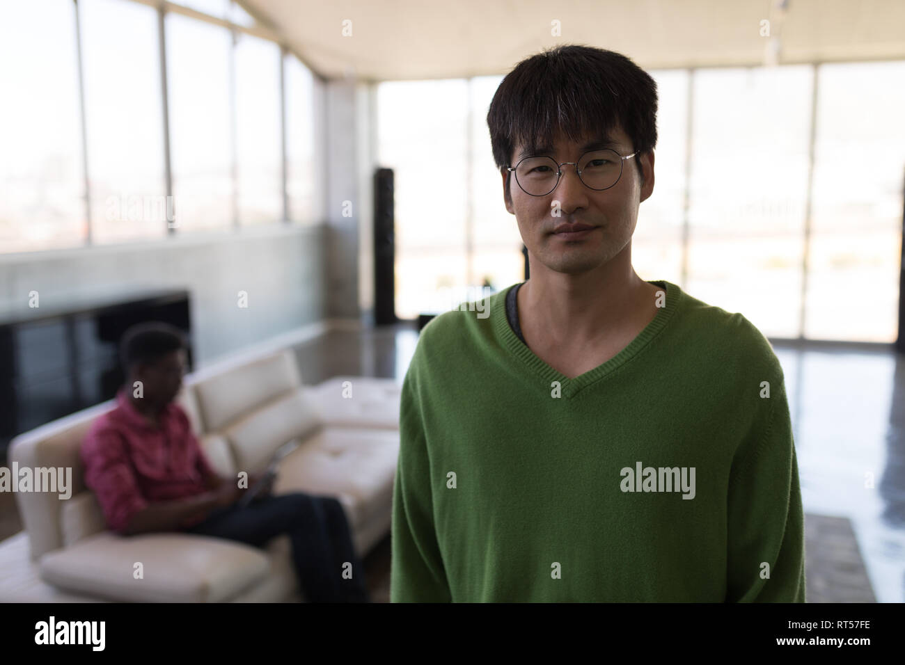 Male executive standing in office Stock Photo - Alamy