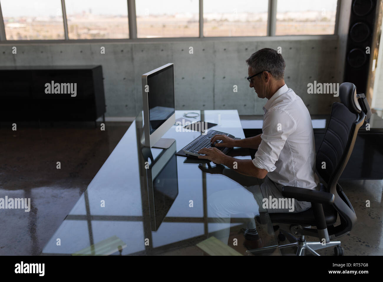 Male executive working on computer at desk Stock Photo - Alamy