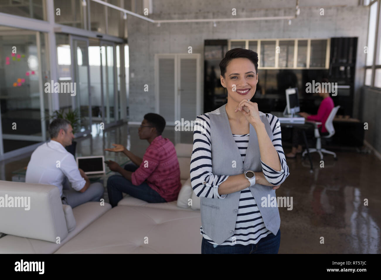Female executive standing in office Stock Photo - Alamy
