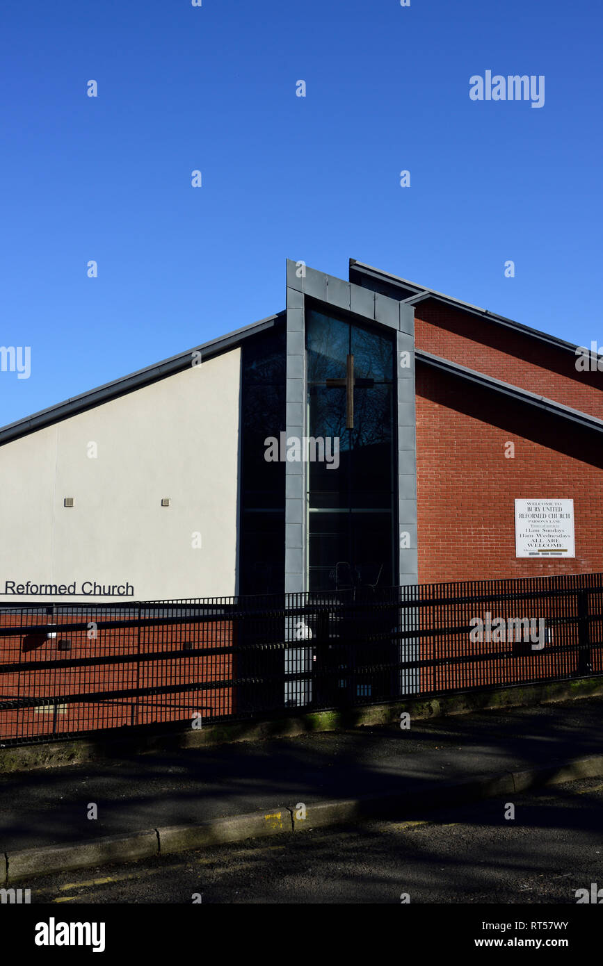 Modern church building in bright sunlight with deep blue sky and no ...