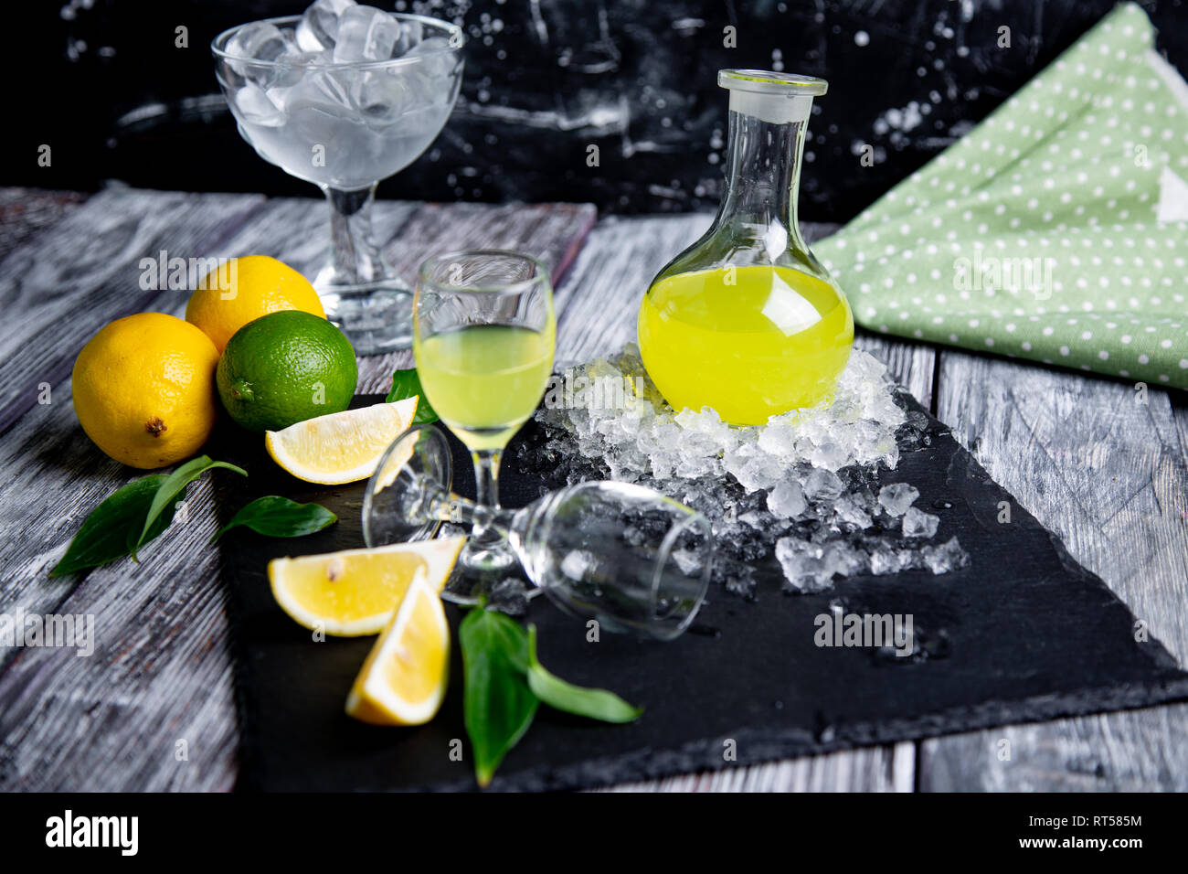 Italian typical digestive limoncello with fresh lemons, selective focus ...