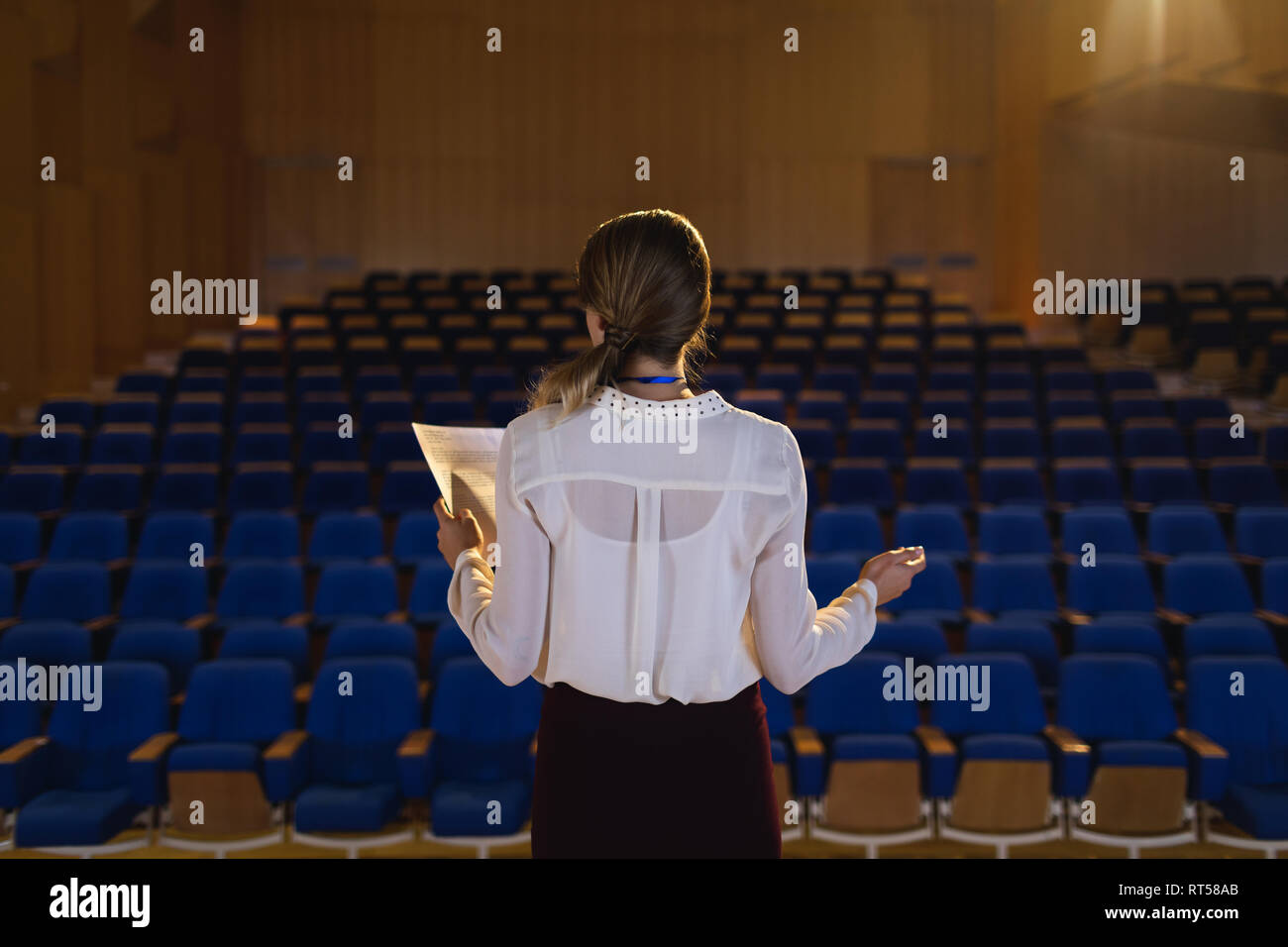 Businesswoman practicing and learning script while standing in the ...