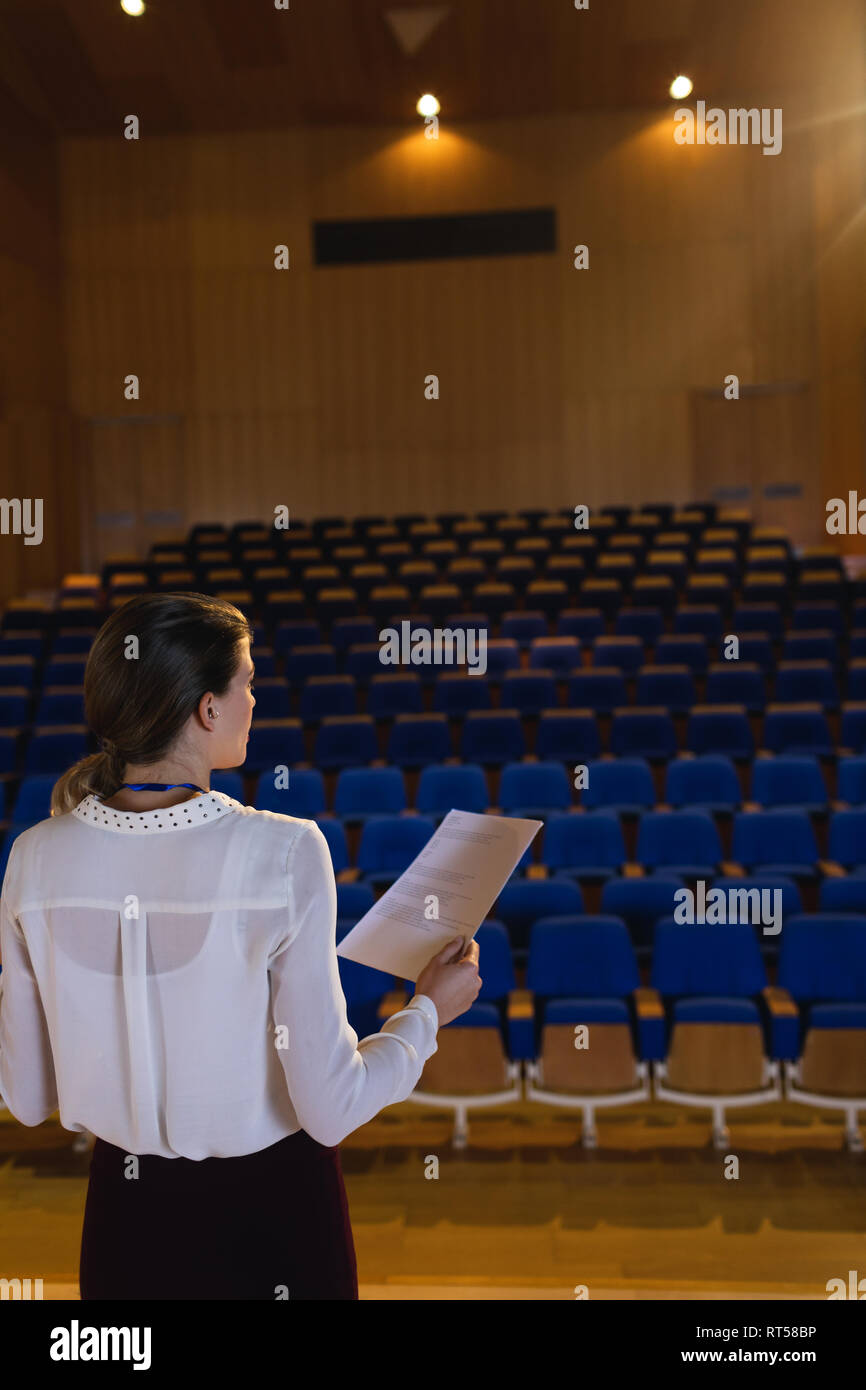 Businesswoman practicing and learning script while standing in the ...