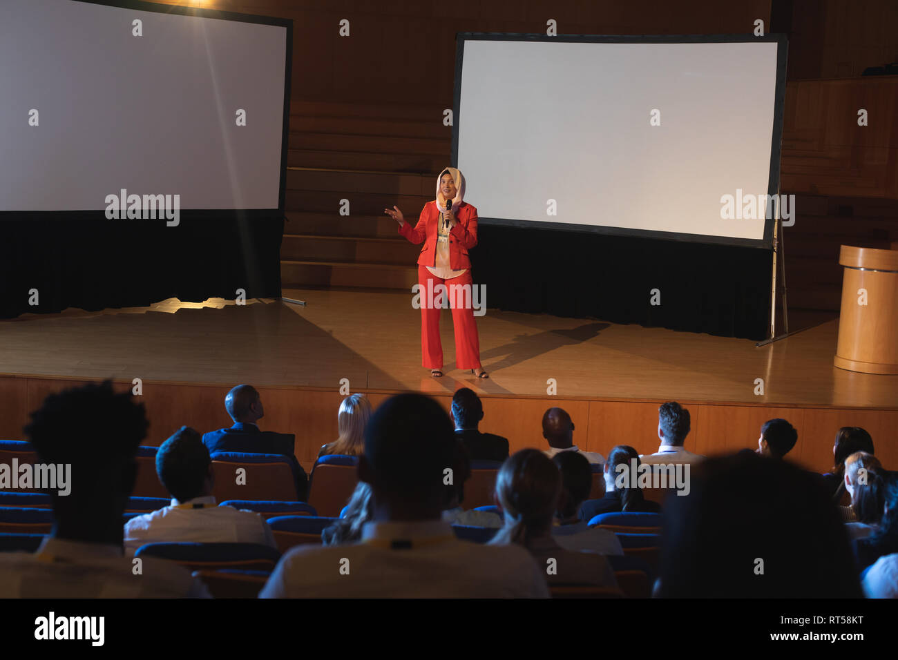 Businesswoman standing auditorium seats hi-res stock photography and ...