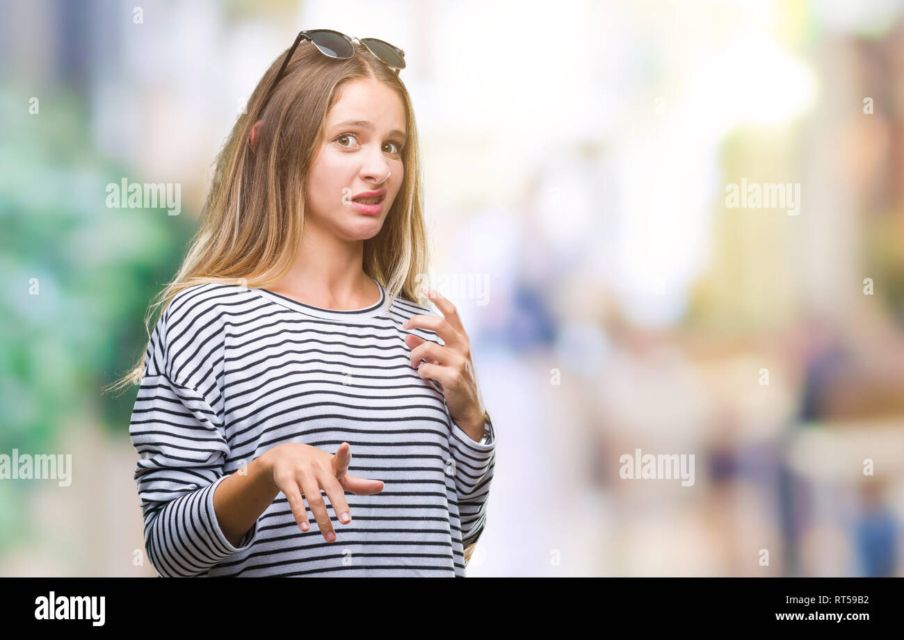 Young beautiful blonde woman wearing sunglasses over isolated ...