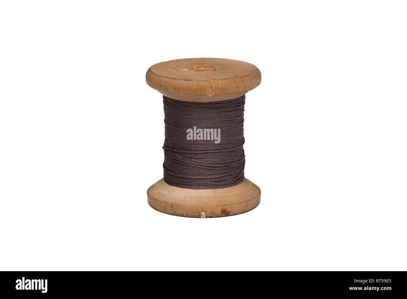 Wooden coil with sewing thread on a white background Stock Photo - Alamy