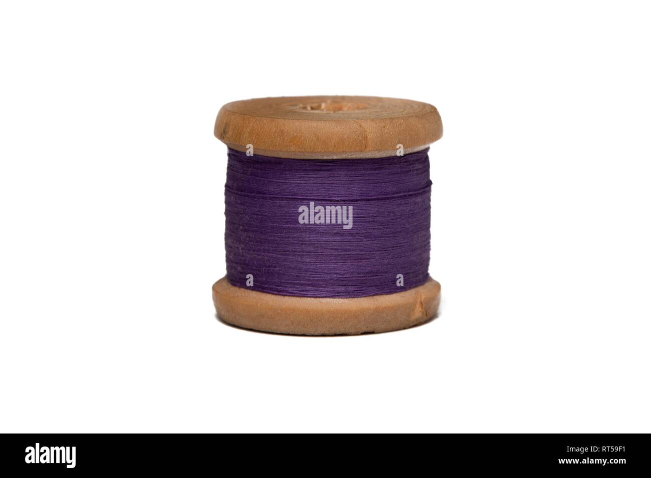 Wooden coil with sewing thread on a white background Stock Photo - Alamy