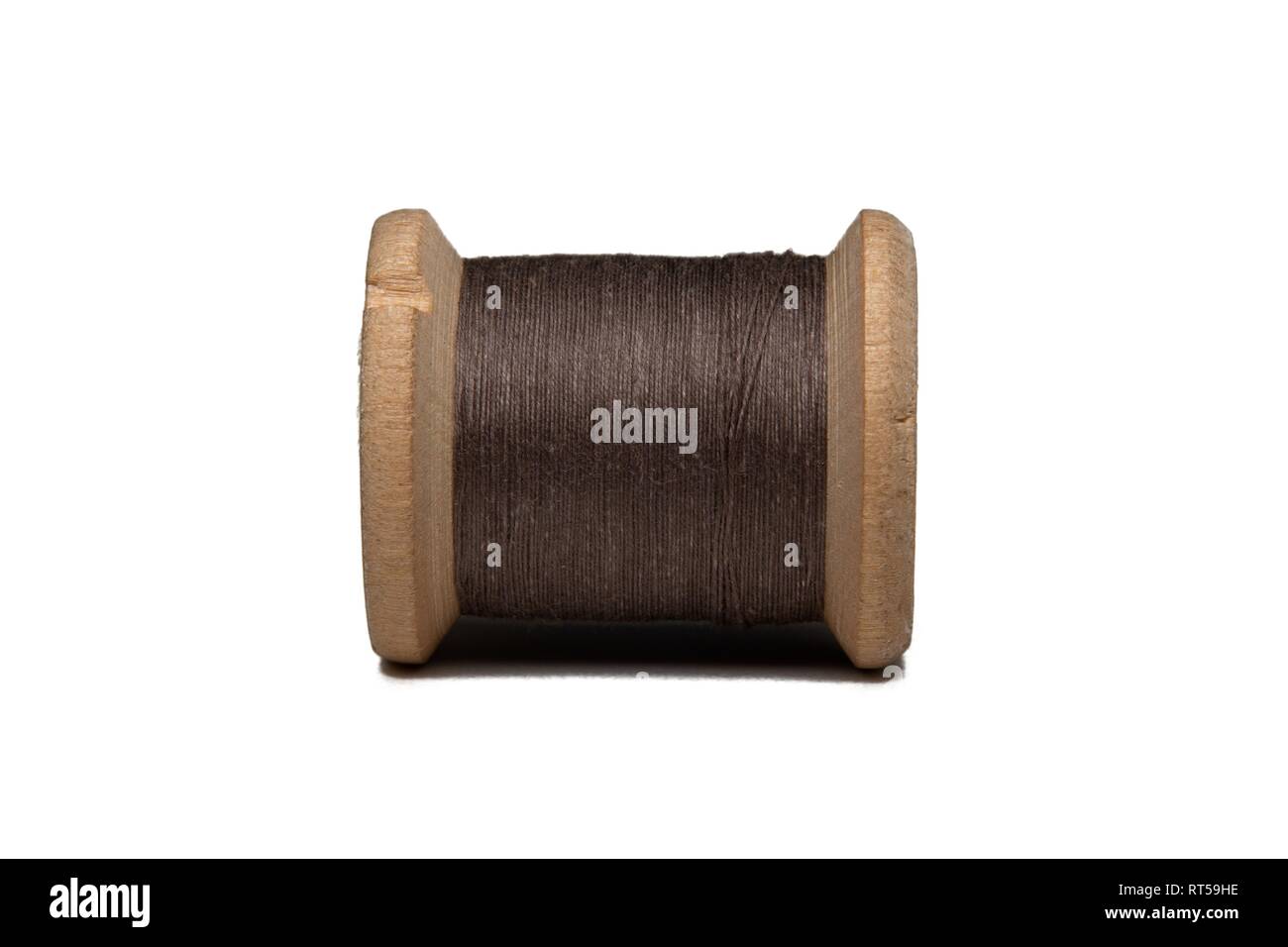 Wooden coil with sewing thread on a white background Stock Photo - Alamy