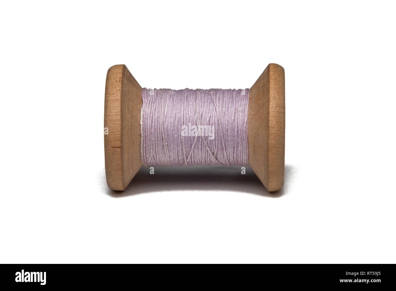 Wooden coil with sewing thread on a white background Stock Photo - Alamy