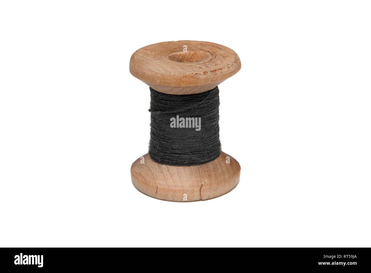 Wooden coil with sewing thread on a white background Stock Photo - Alamy