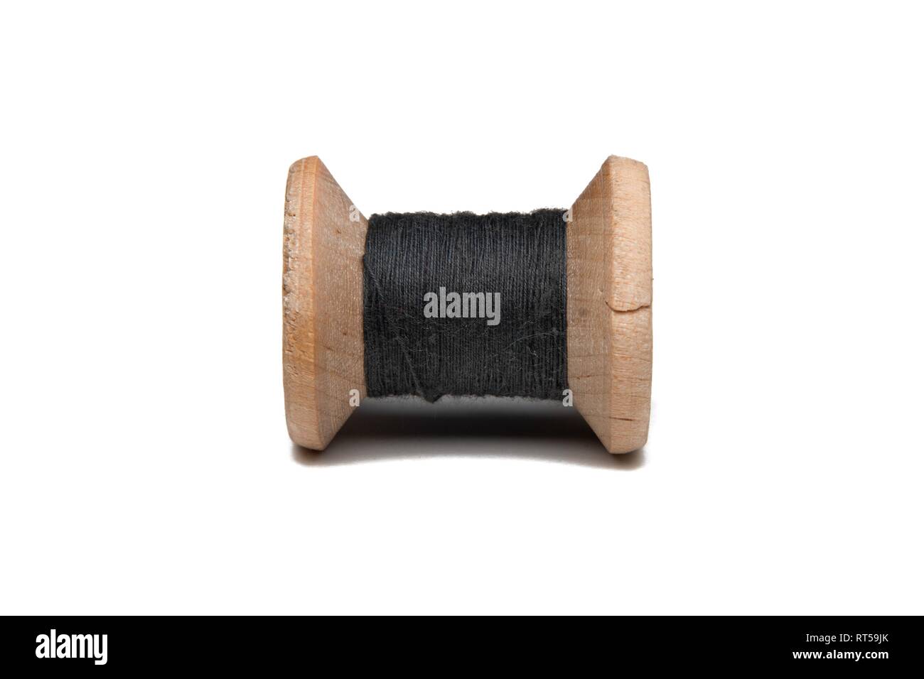 Wooden coil with sewing thread on a white background Stock Photo - Alamy