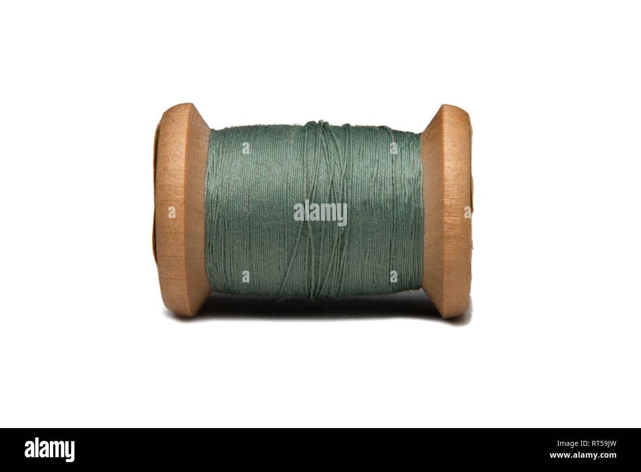 Wooden coil with sewing thread on a white background Stock Photo - Alamy