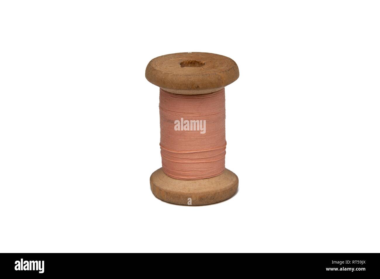 Wooden coil with sewing thread on a white background Stock Photo - Alamy
