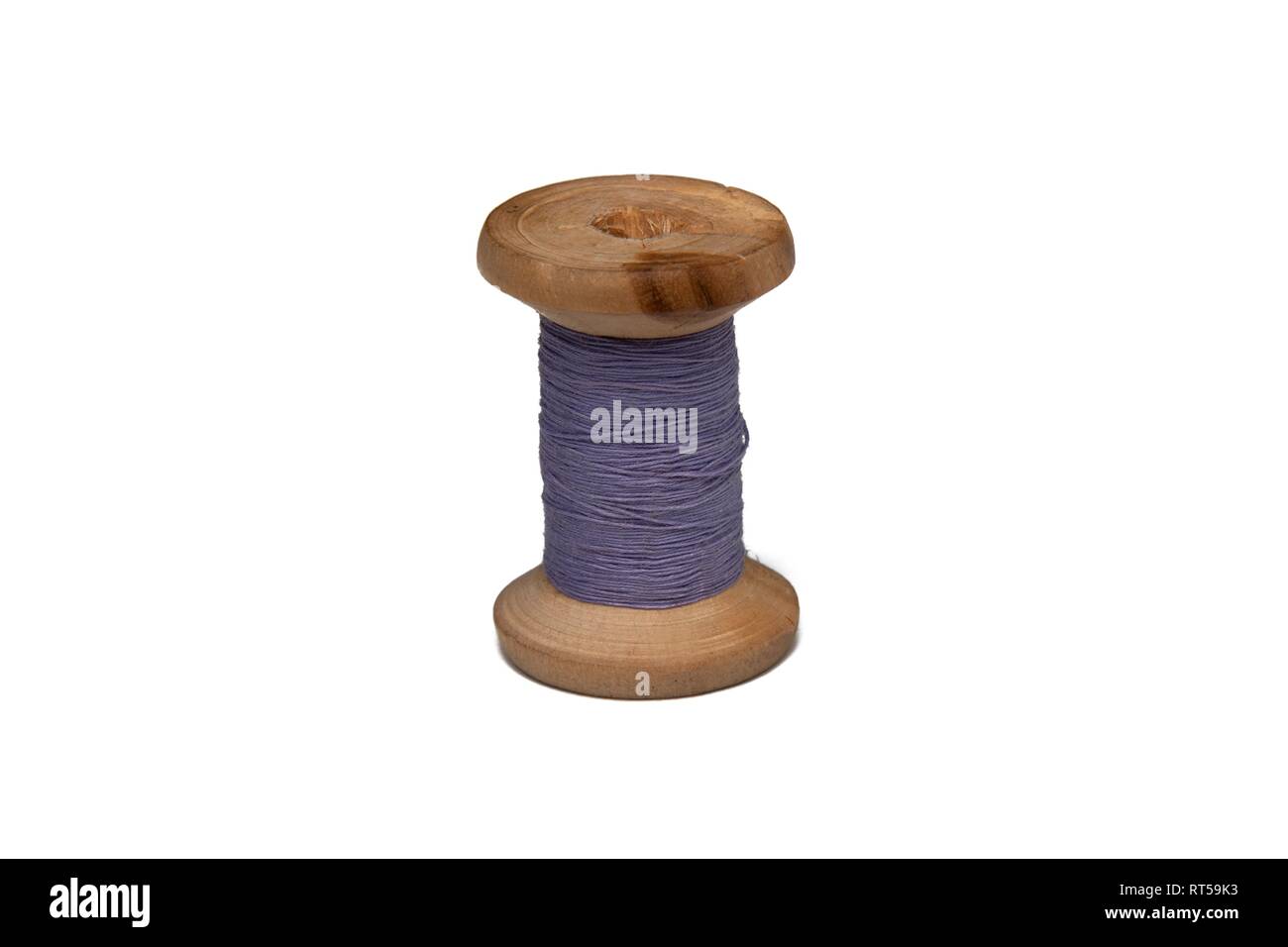 Wooden coil with sewing thread on a white background Stock Photo - Alamy