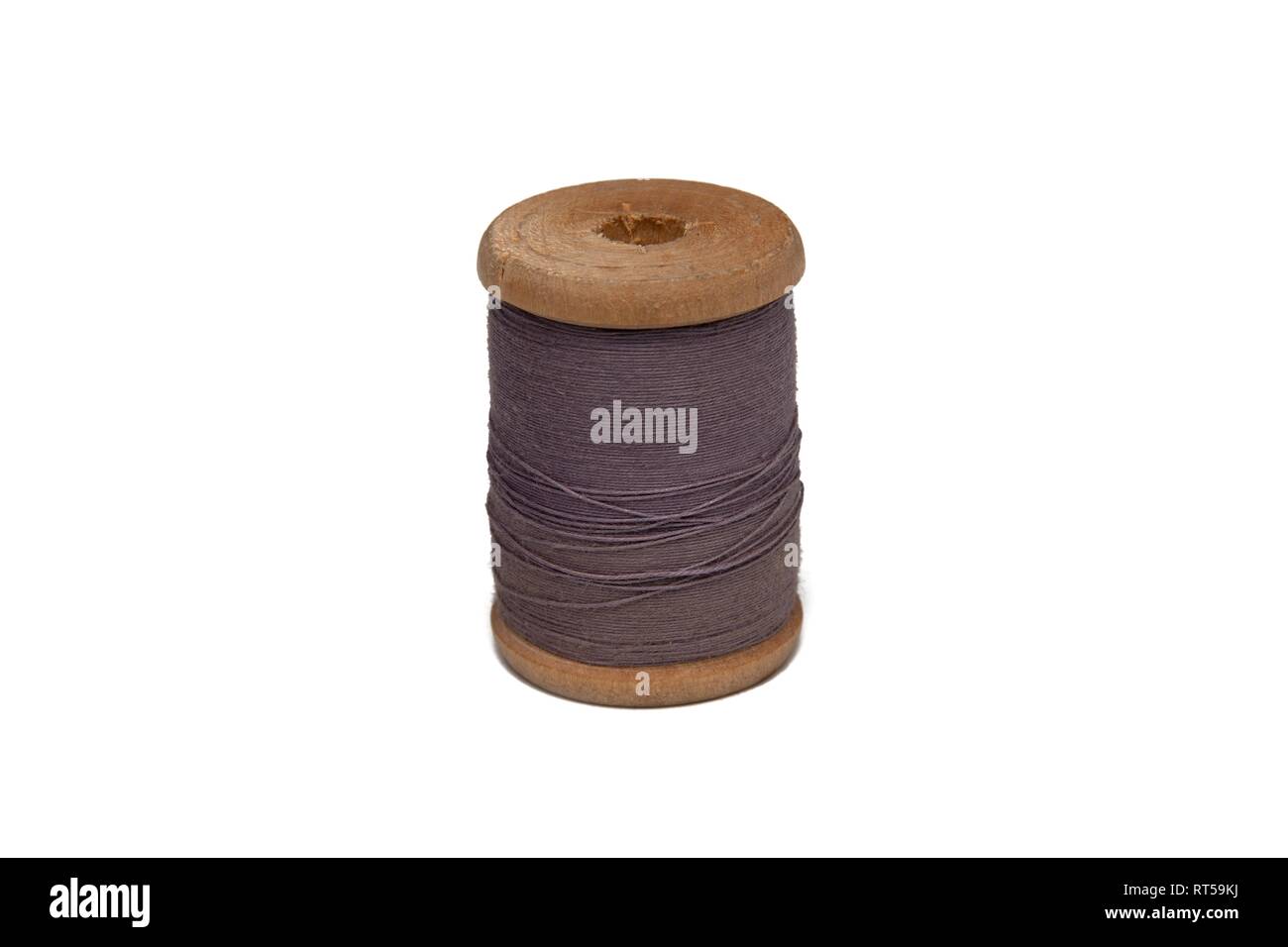 Wooden coil with sewing thread on a white background Stock Photo - Alamy