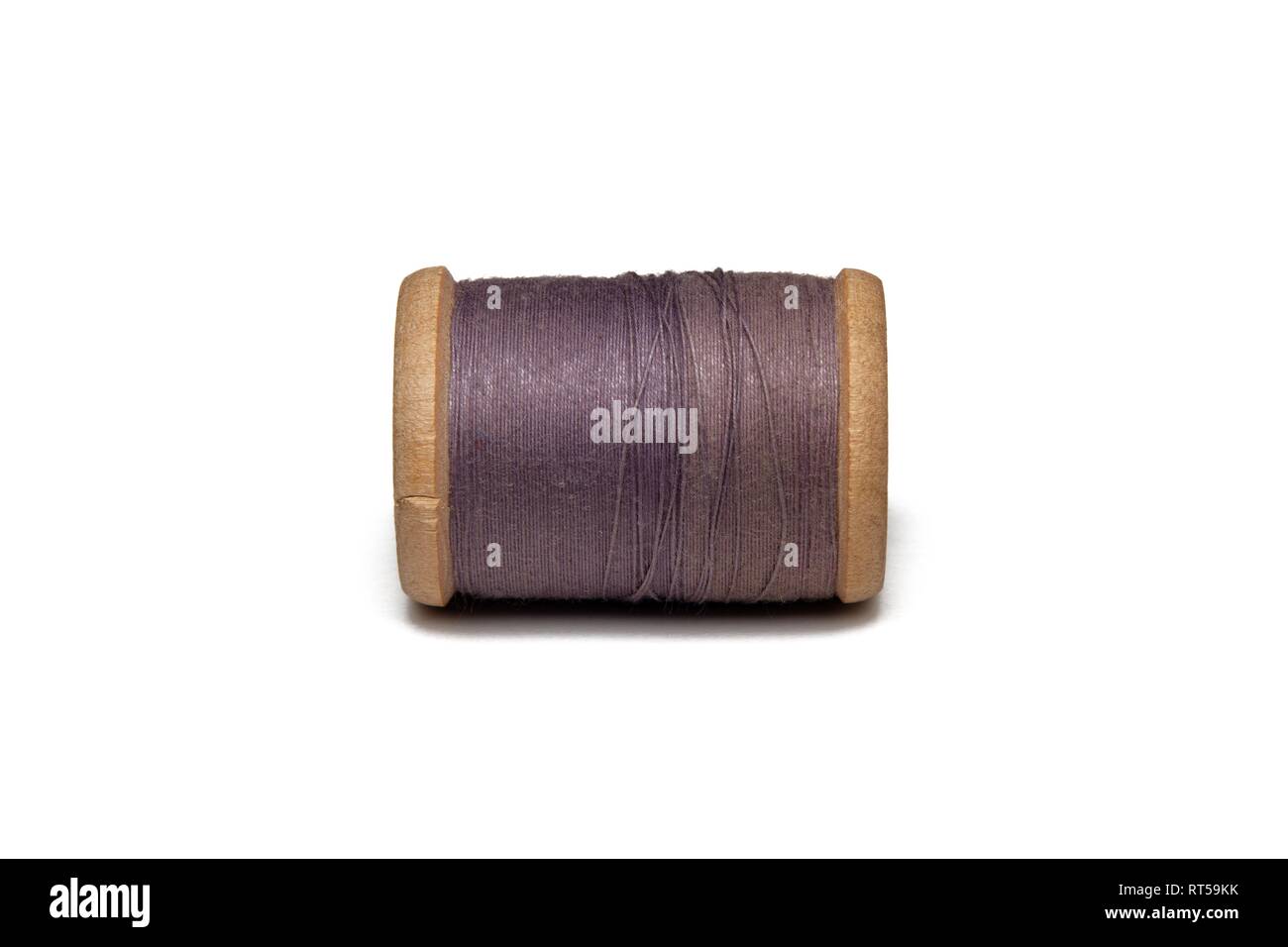 Wooden coil with sewing thread on a white background Stock Photo - Alamy