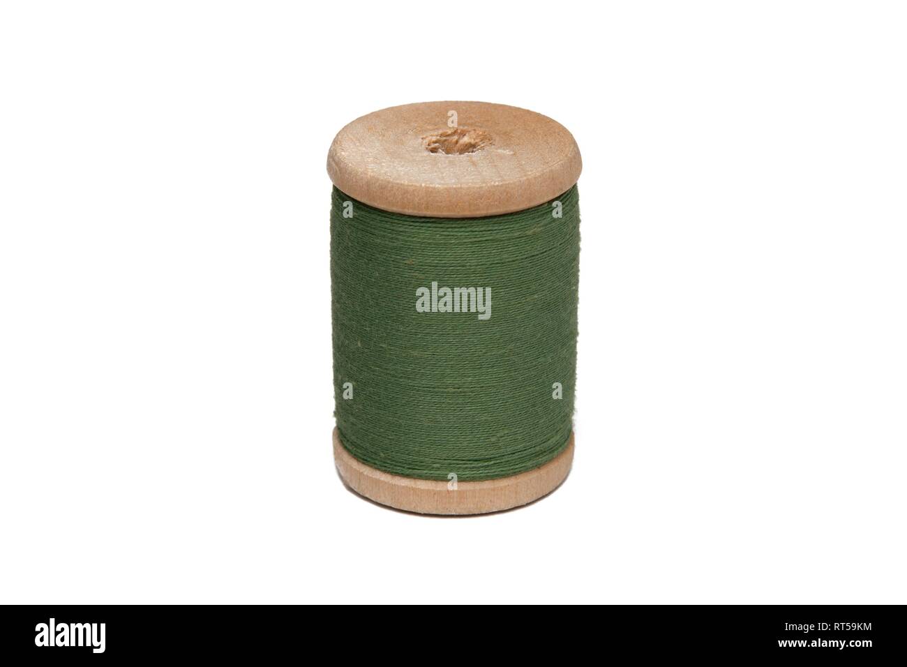 Wooden coil with sewing thread on a white background Stock Photo - Alamy