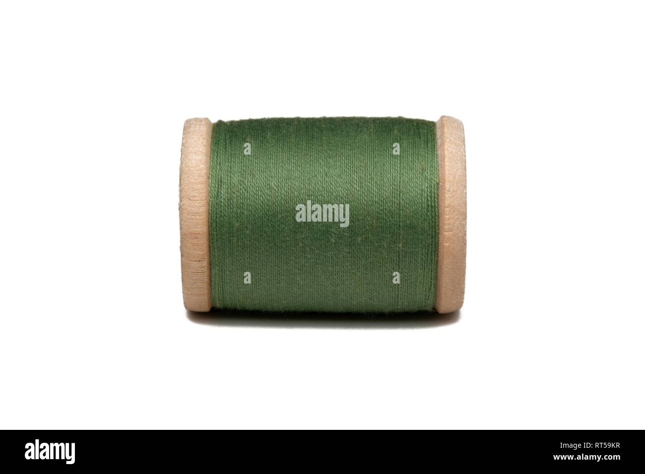 Wooden coil with sewing thread on a white background Stock Photo - Alamy