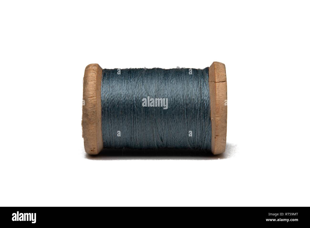 Wooden coil with sewing thread on a white background Stock Photo - Alamy