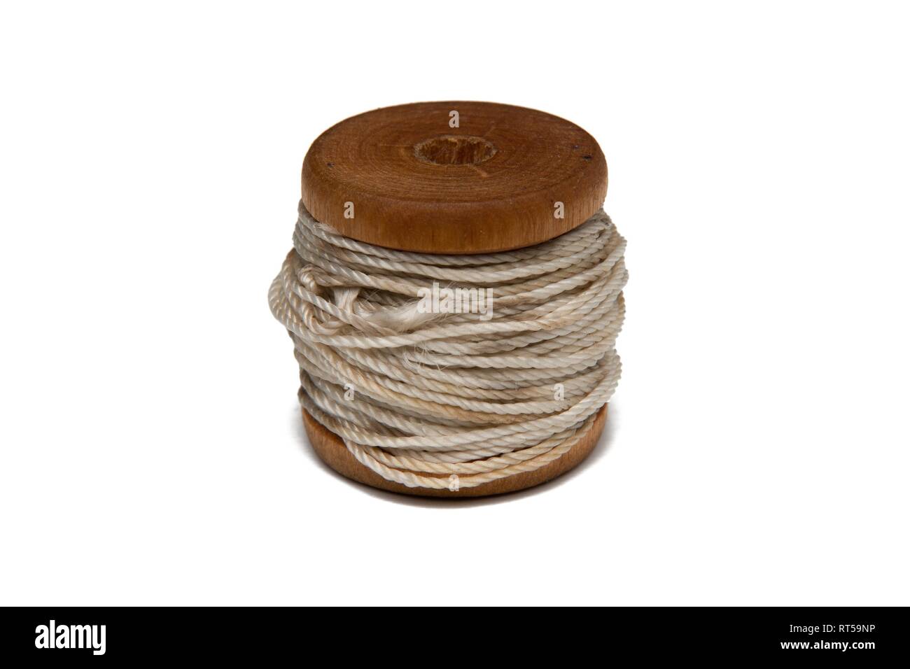 Wooden coil with sewing thread on a white background Stock Photo - Alamy
