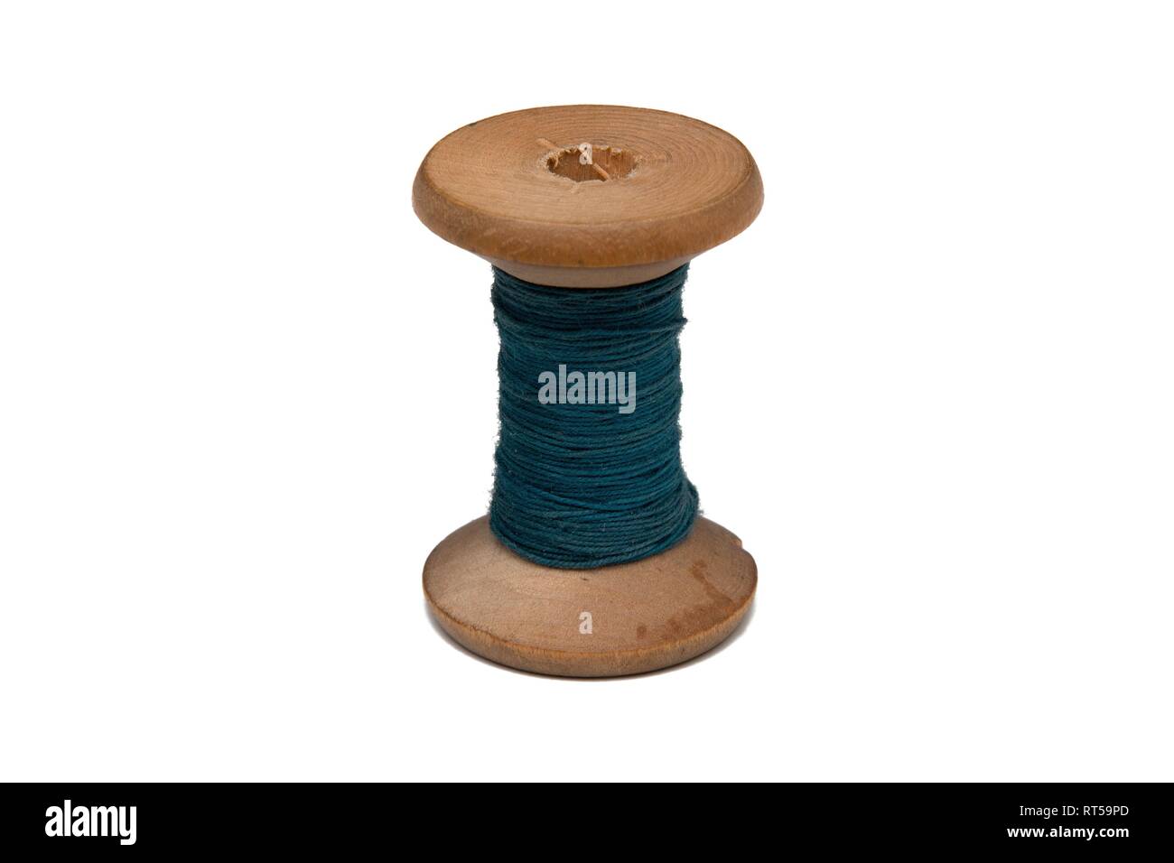 Wooden coil with sewing thread on a white background Stock Photo - Alamy