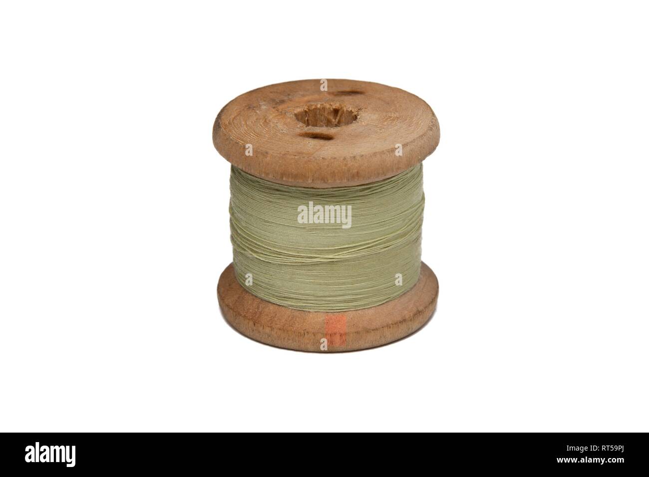 Wooden coil with sewing thread on a white background Stock Photo - Alamy