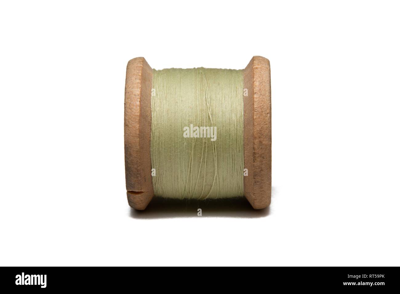 Wooden coil with sewing thread on a white background Stock Photo - Alamy