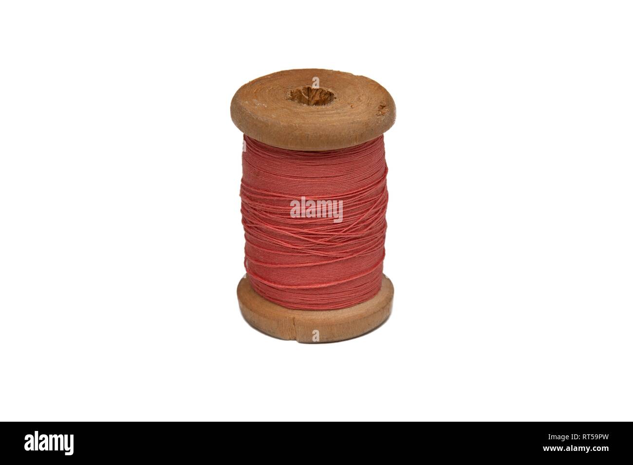 Wooden coil with sewing thread on a white background Stock Photo - Alamy