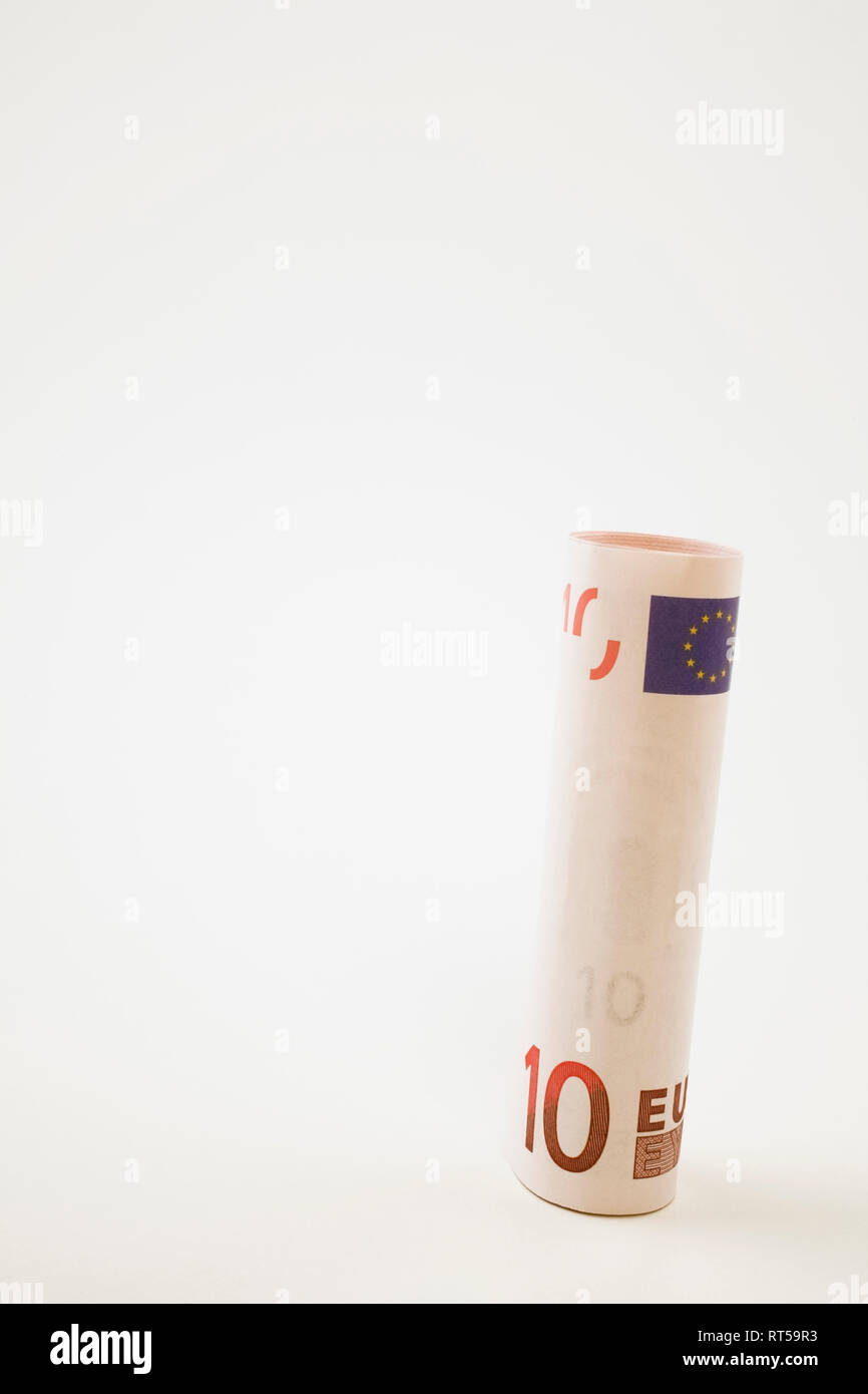 Close-up of a rolled-up upright 10 Euro paper currency banknote on ...